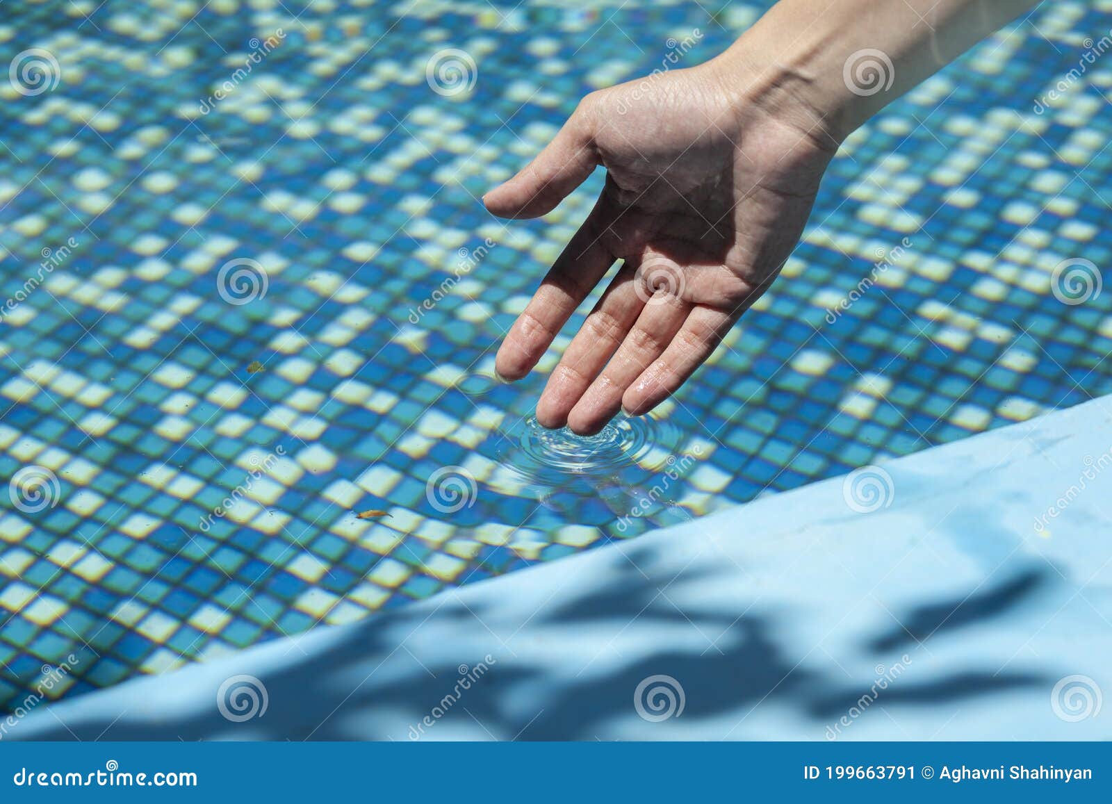 The woman hand in the pool stock image. Image of glare - 199663791