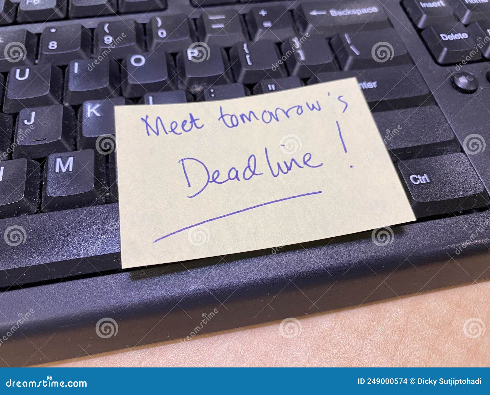A Reminder Label Note To Meet a Deadline Placed on Top of a Black ...