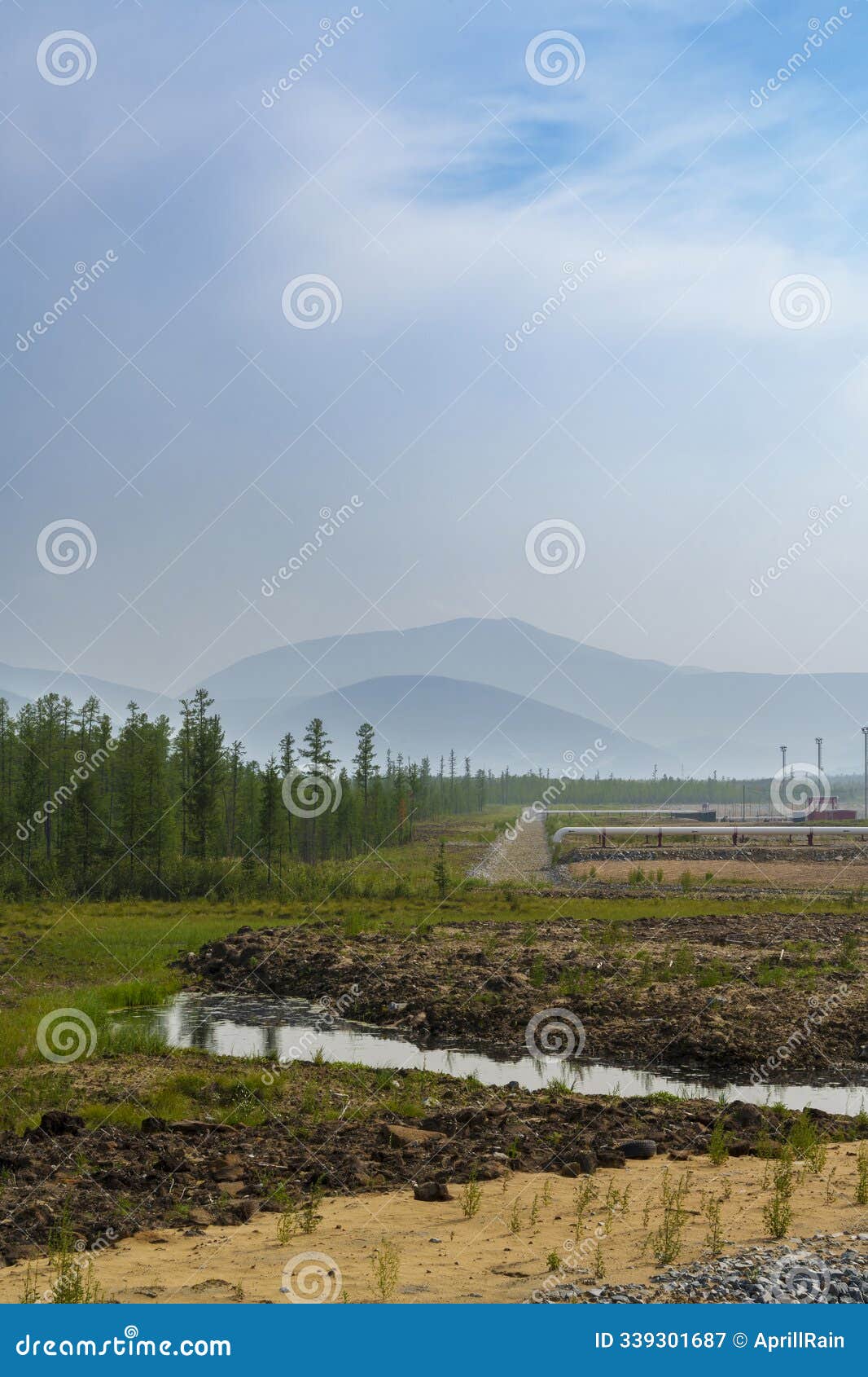 Remote Construction Site with Dirt Road and Distant Mountains Stock ...