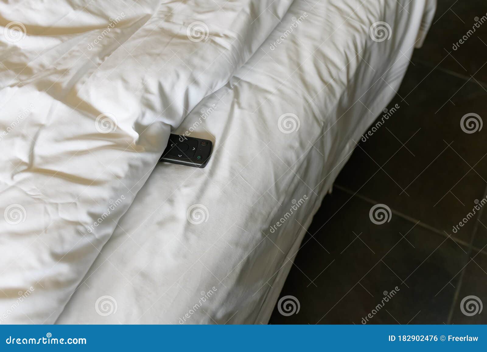 Remote control on bed stock photo. Image of switch, electronic - 182902476