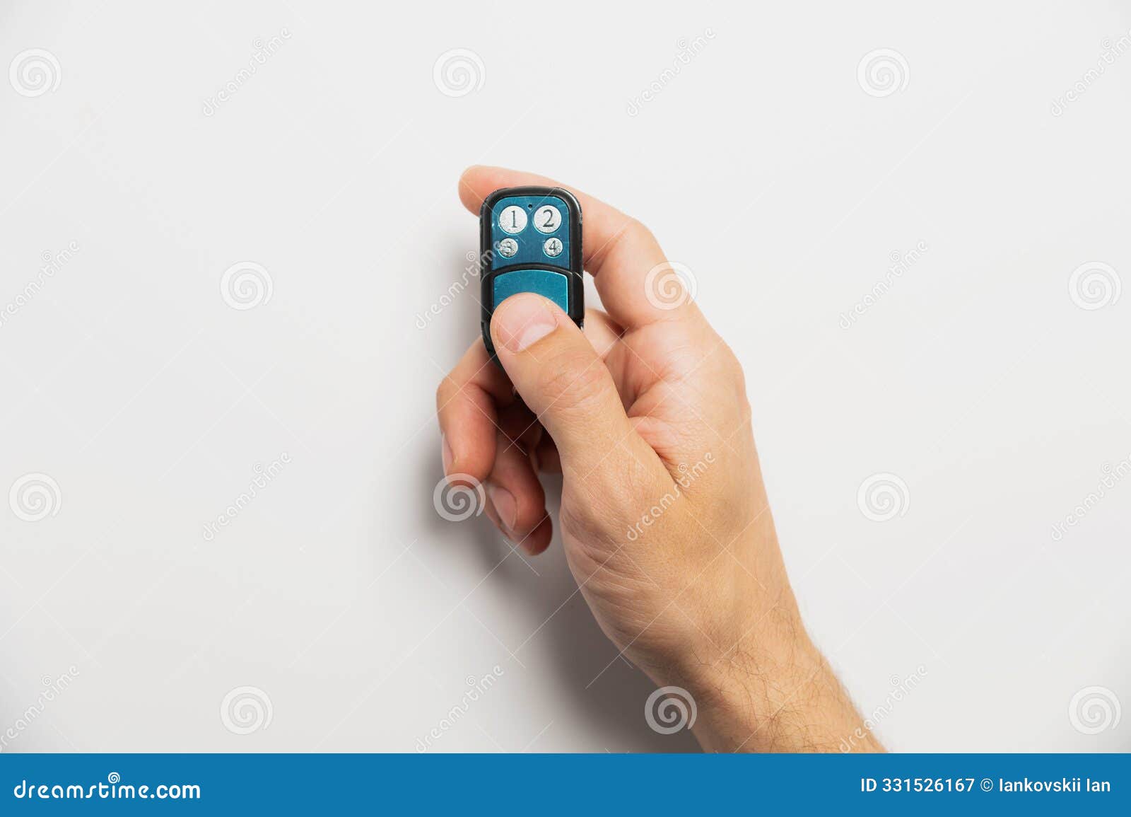 Remote Control for Door or Garage or Gate in Male Hand on White ...