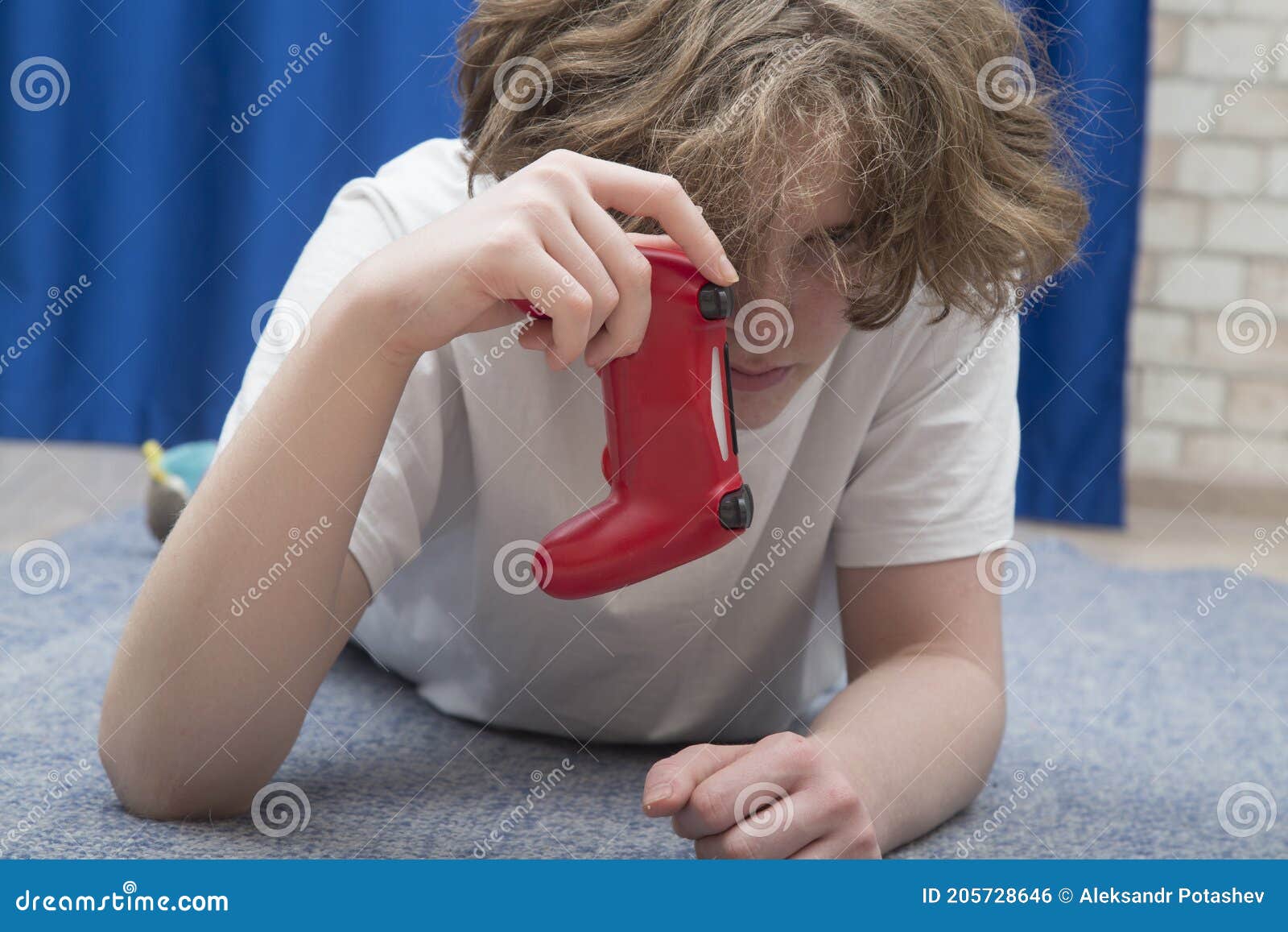 Remote Control for a Game Console.a Young Man is Playing a Game Console ...