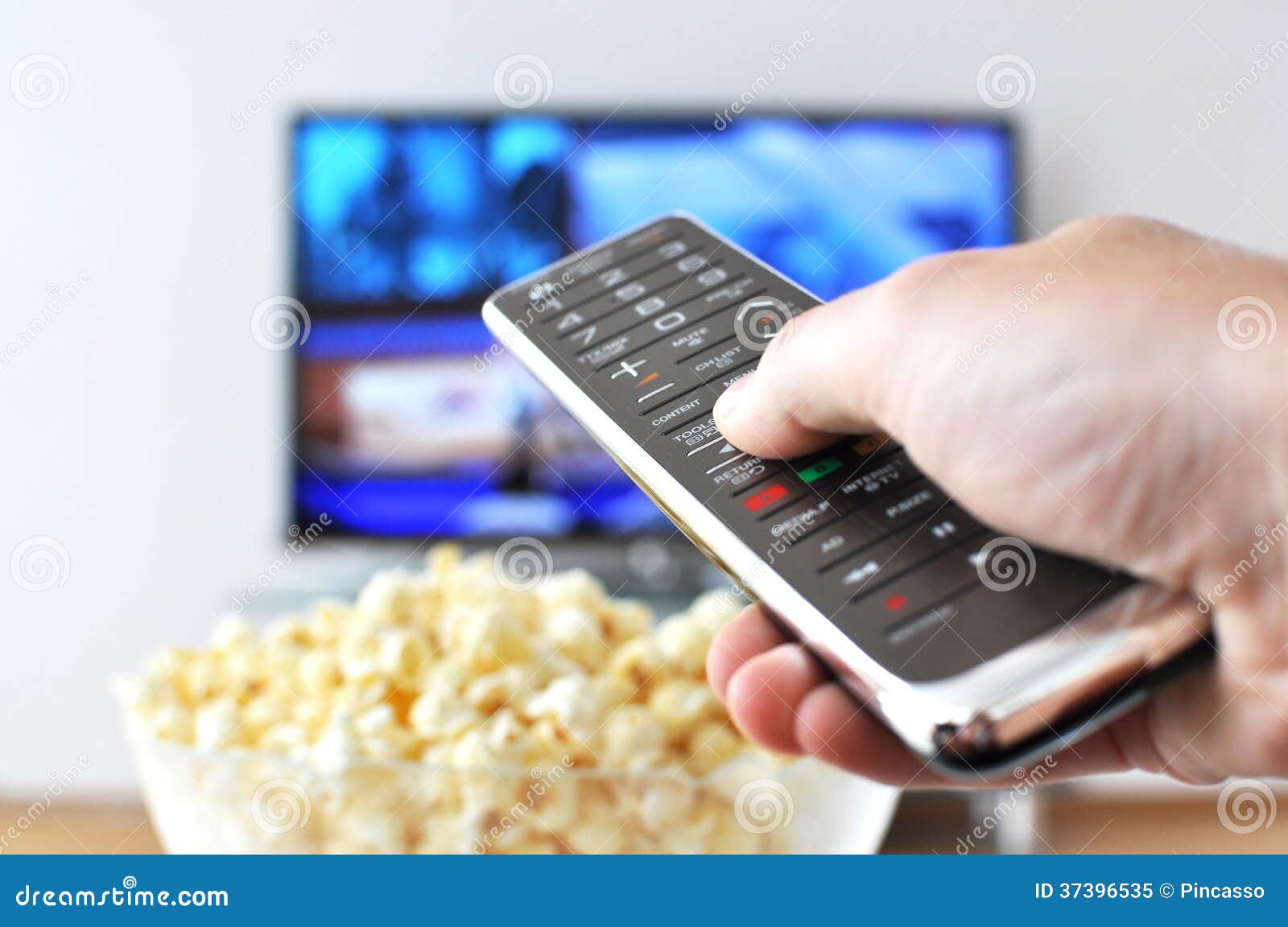 Remote control in the hand stock image. Image of popcorn - 37396535