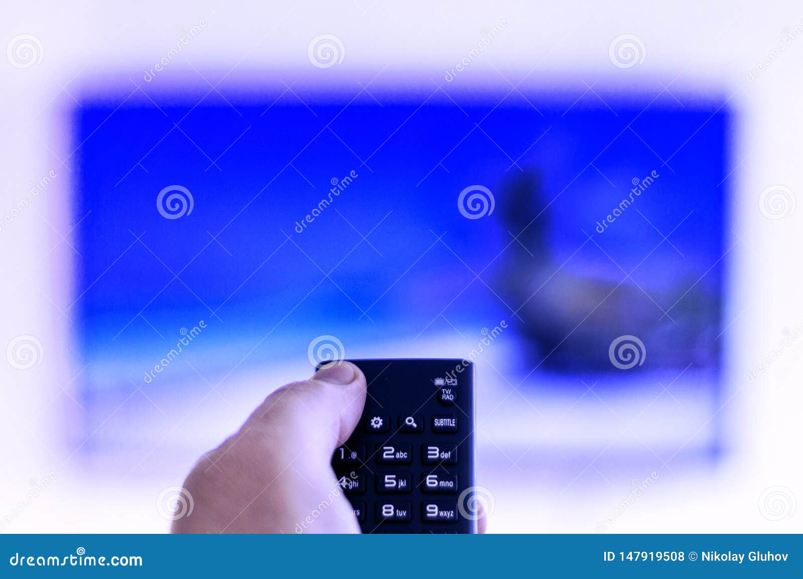 The Remote Control is in the Hand of a Man, Directed To a Large-screen ...