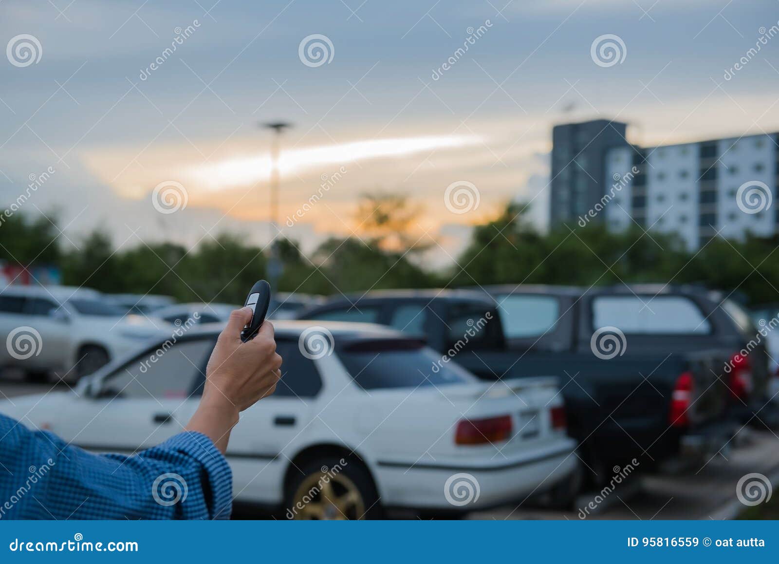 Remote Control Key Car in Hand in the Outdoor Parking Lot at Evening ...