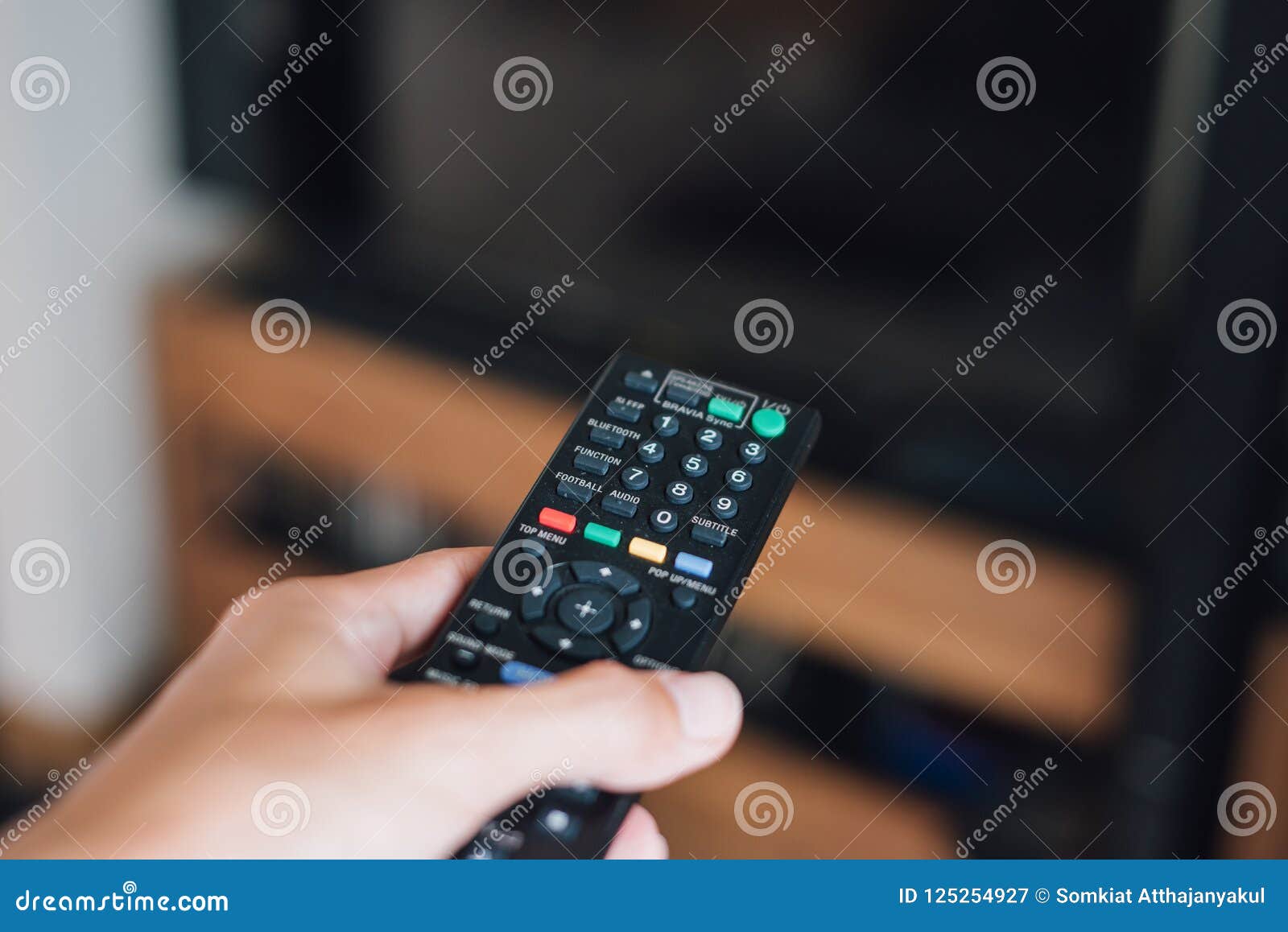 Remote Control with Television Background in a Living Room. Stock Image ...