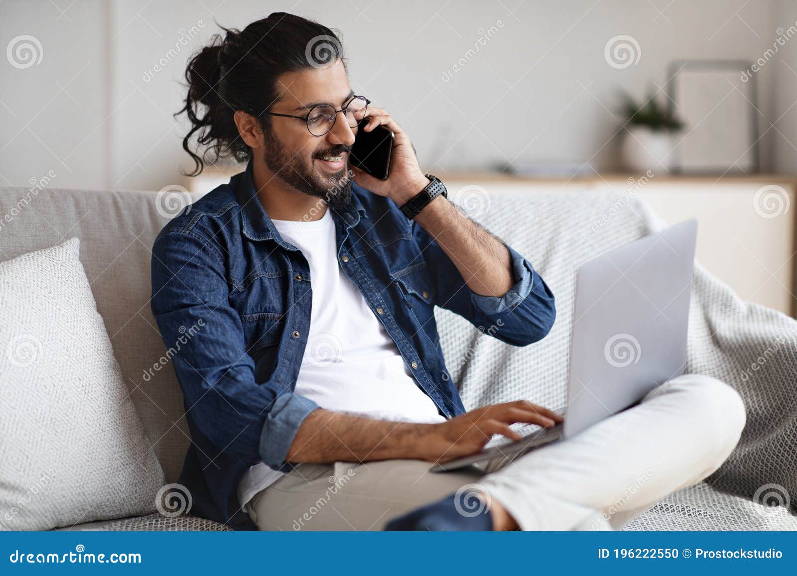 Remote Work. Freelancer Guy Using Laptop and Having Phone Conversation ...