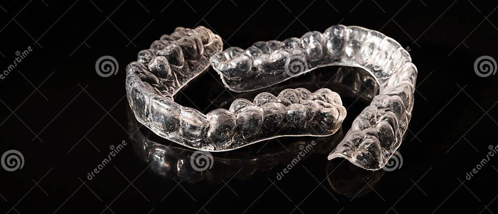 Removable Plastic Retainers for Bite Correction on a Black Background ...