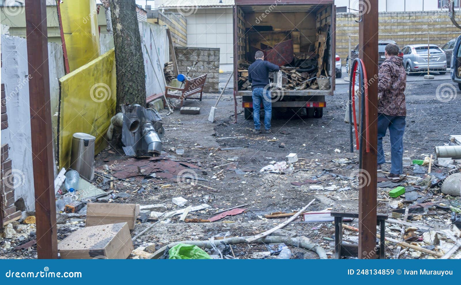 Removal of Construction Debris. Loading the Garbage Can Waste ...