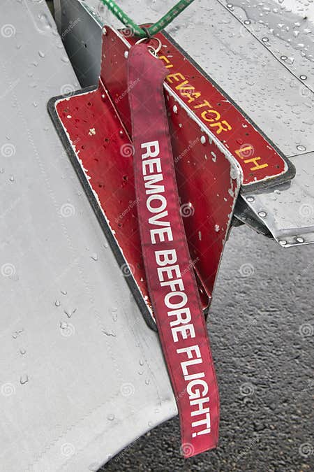 A Remove before Flight Ribbon on a Airplane Stock Image - Image of ...