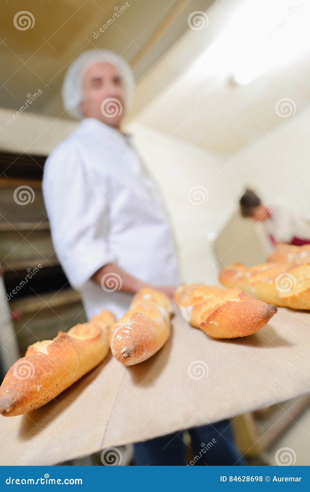 Removing Fresh Bread Sticks from Oven Stock Photo - Image of ...