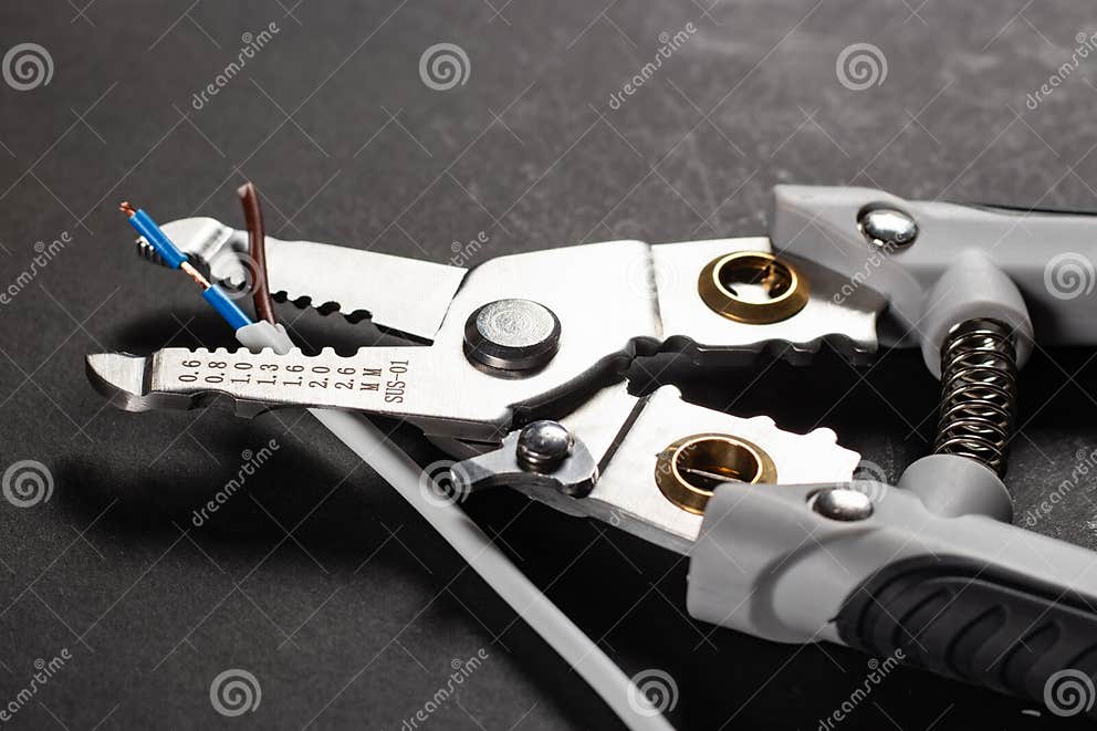Removing the Insulation from the Conductor Using a Tool. Wire Stripping ...
