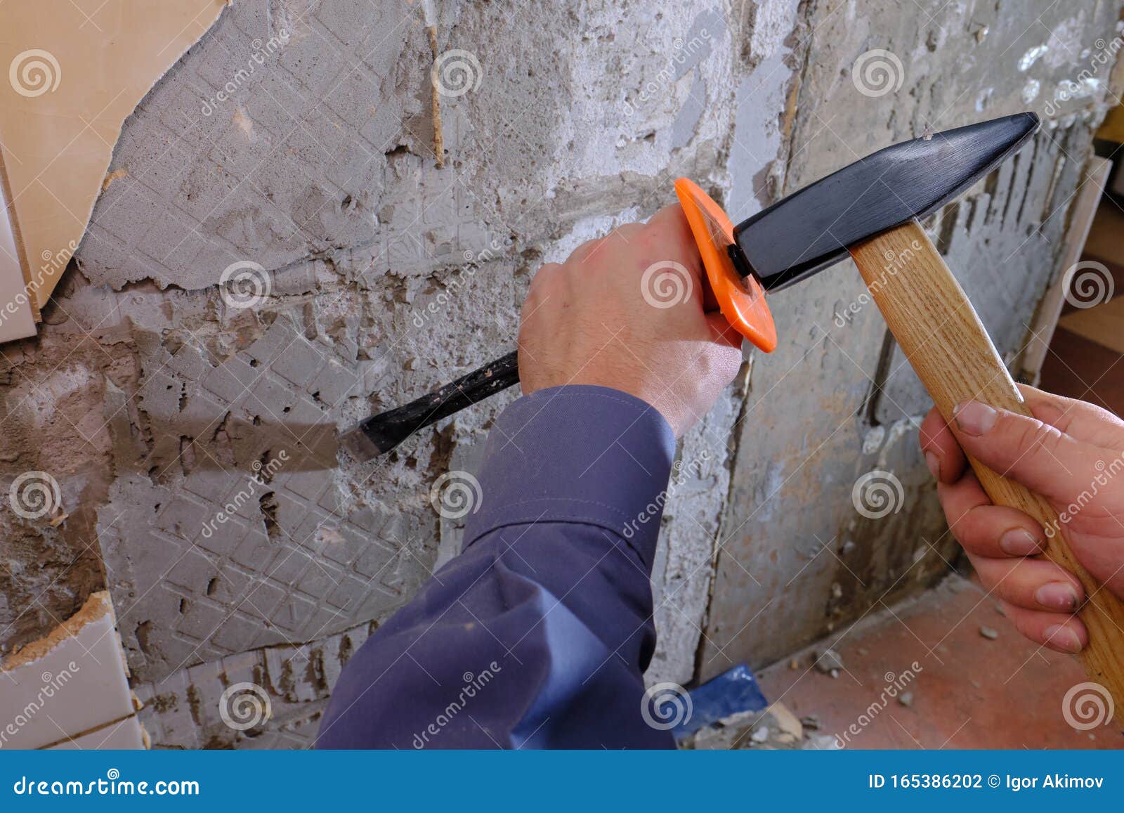 Removing Old Tiles from the Wall in the Kitchen Using a Chisel with a ...