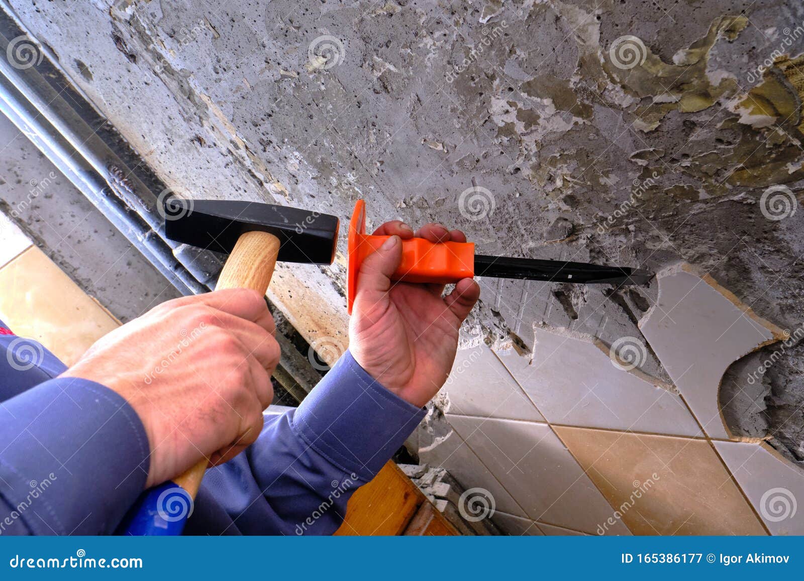 Removing Old Tiles from the Wall in the Kitchen Using a Chisel with a ...