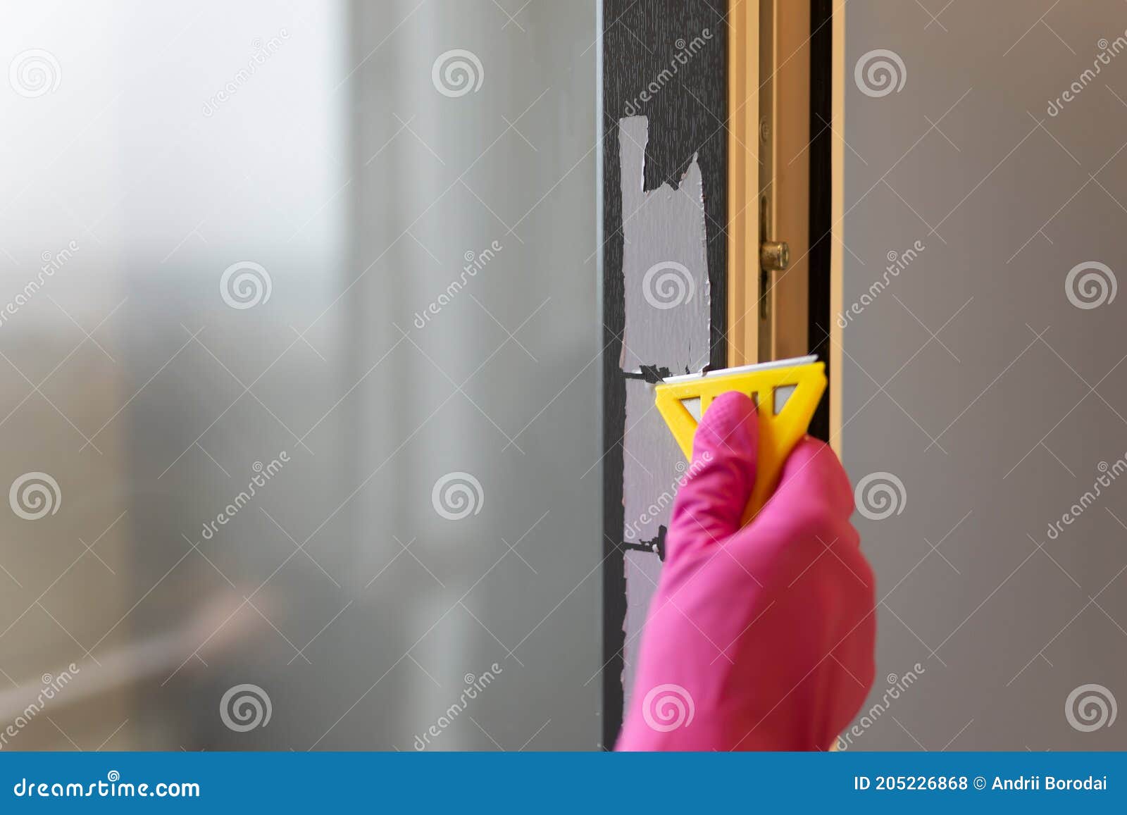 Removing Protective Tape from the Window Frame with Scraper. Stock ...