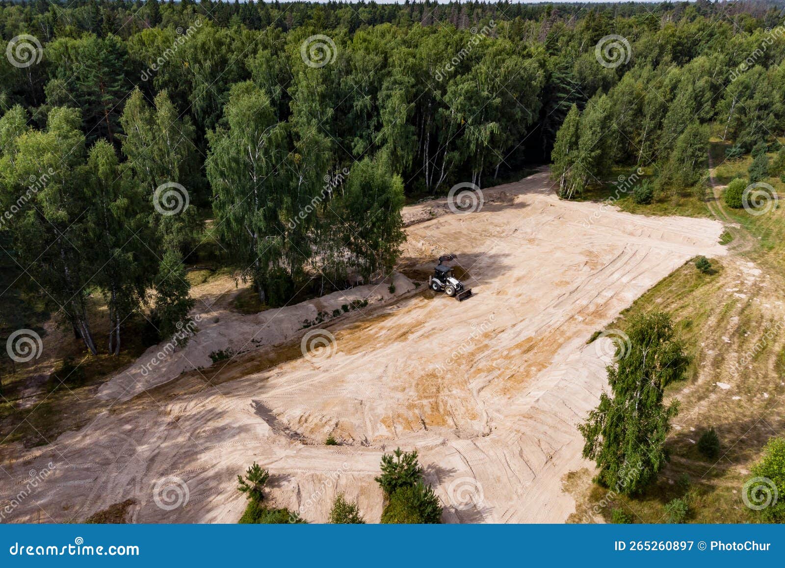 Removing the Top Layer of Earth in the Forest with a Tractor before ...