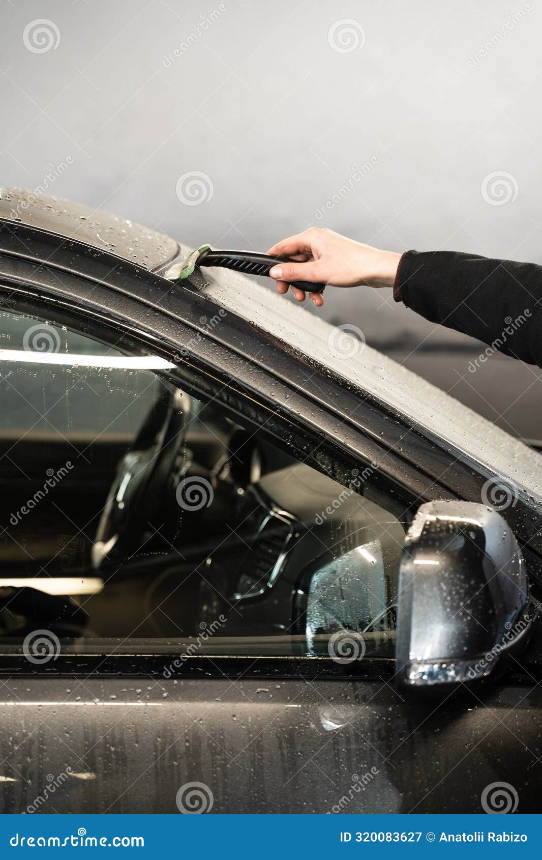 Removing Water from Windscreen Using Scraper at Car Wash Service ...
