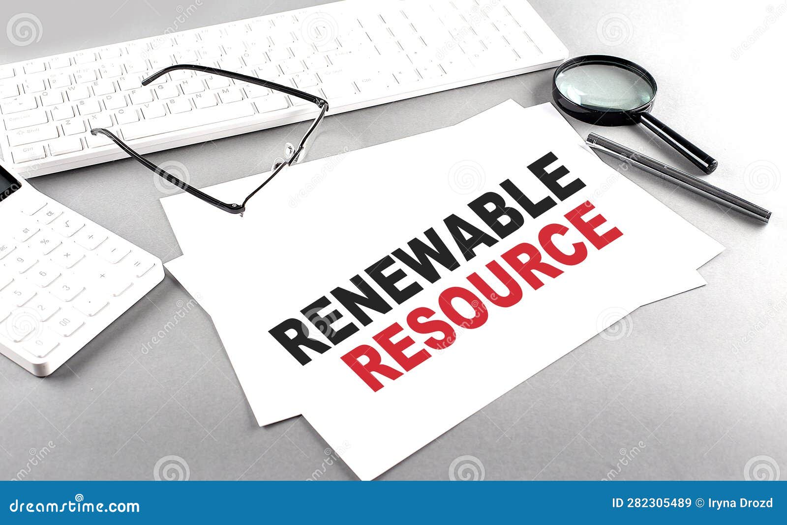 RENEWABLE RESOURCE Text on a Paper with Keyboard, Calculator on Grey ...