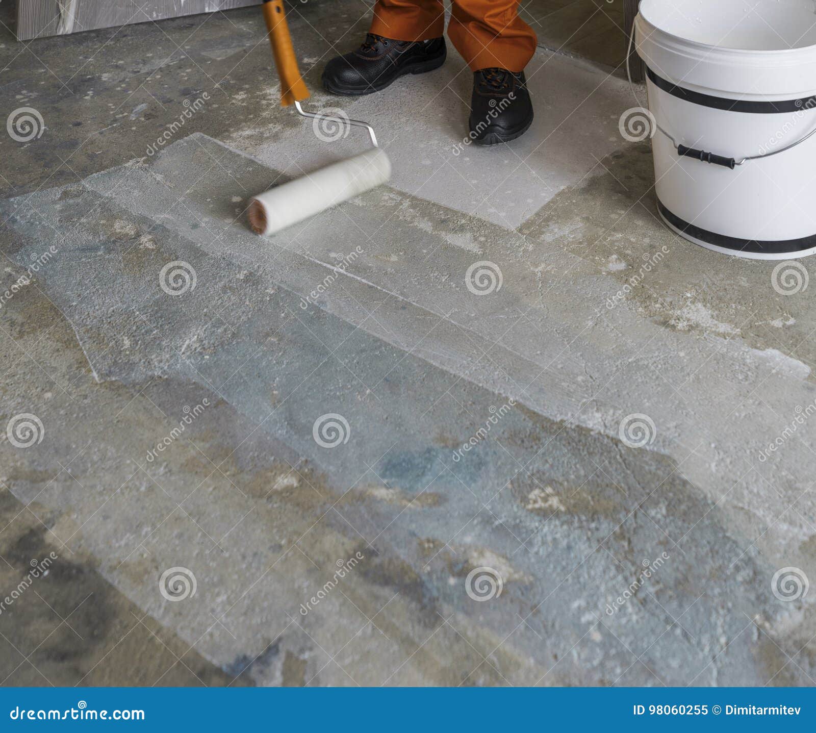 Renovation of House. Worker Puts Primer with Roller on Concrete Stock ...