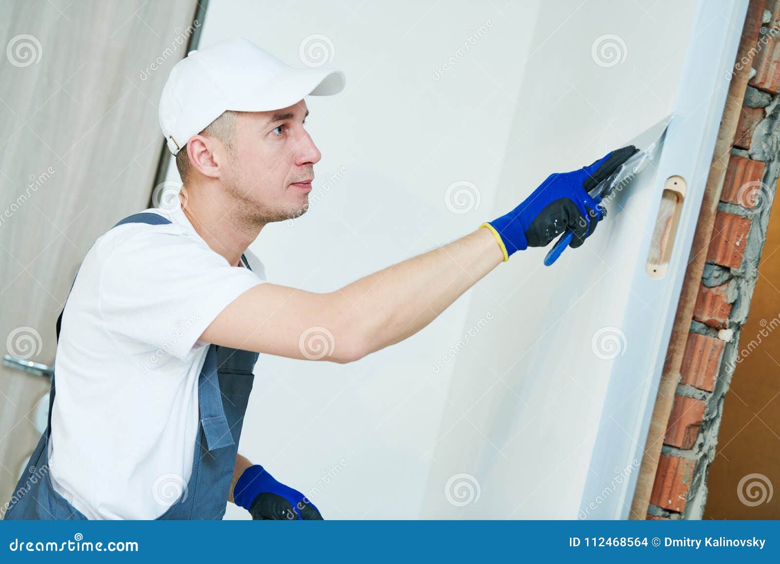 Refurbishment. Worker Spackling a Wall with Putty Stock Photo - Image ...