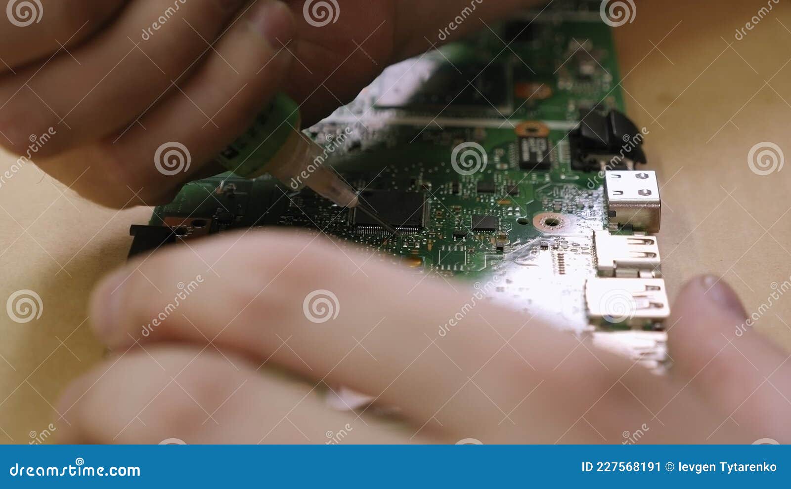 Repair of the Computer Motherboard, Soldering the Microchip. Stock ...
