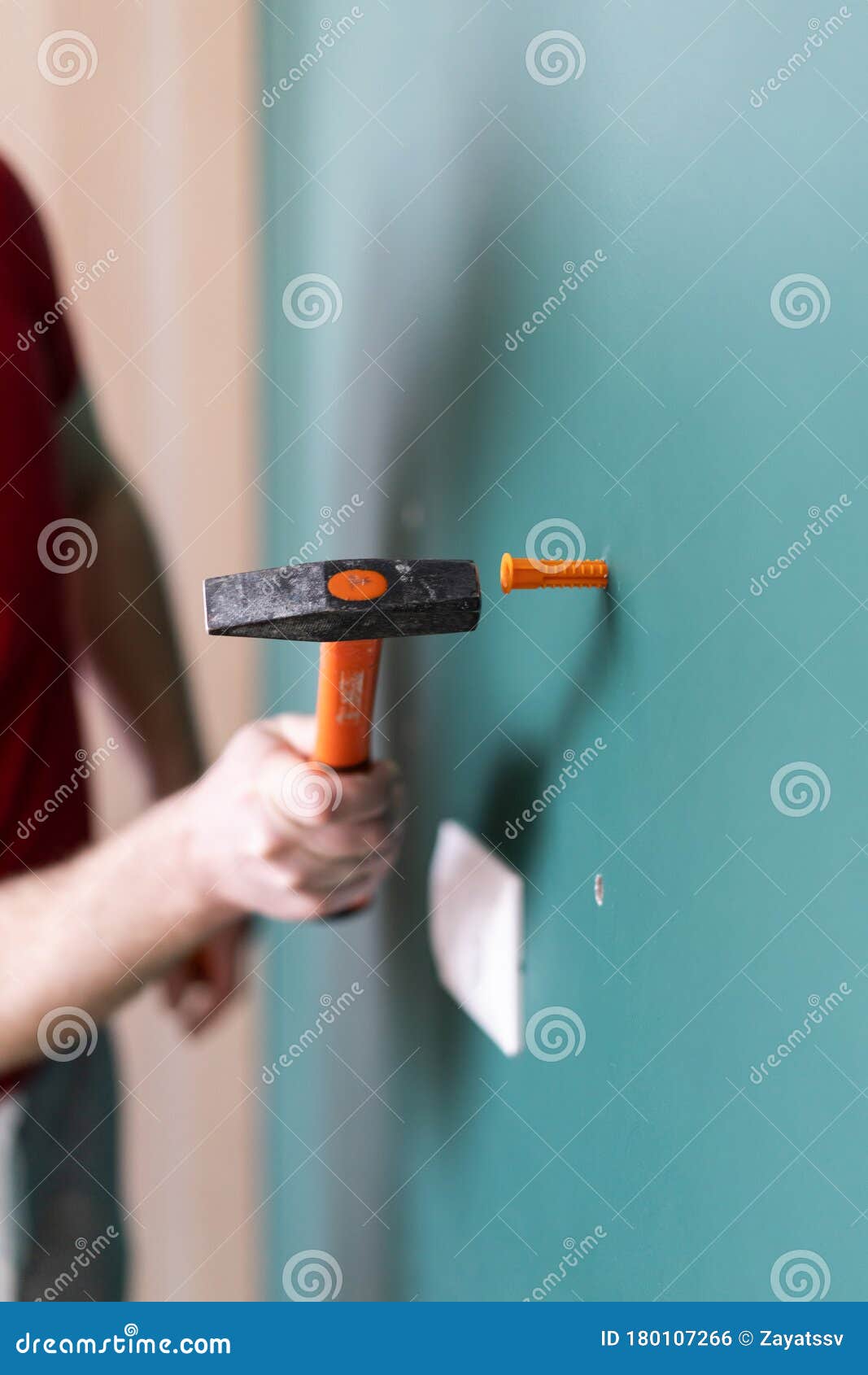 Repair and Decoration. a Man Drives a Wall Plug with a Hammer Stock ...