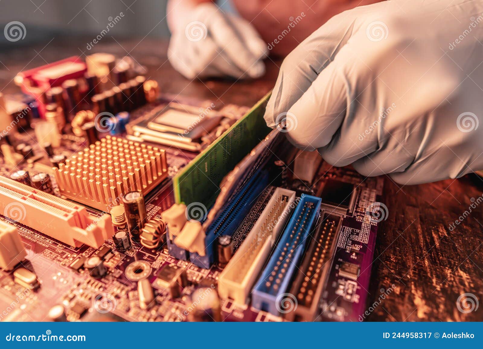 A Repair Engineer Holds a RAM Chip with His Hands, Inserts the RAM into ...