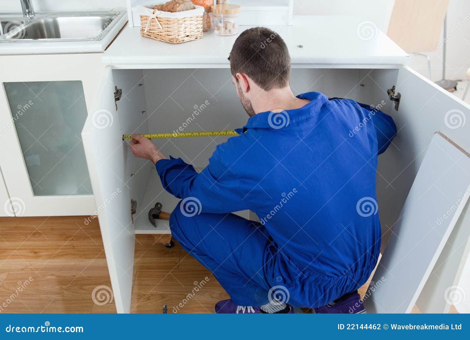 Repair Man Measuring Something Stock Photo - Image of kitchen, blue ...