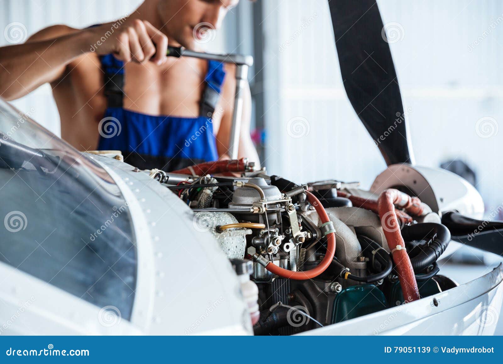 Repair Man in Overall Fixing Engine on a Plane Stock Image - Image of ...