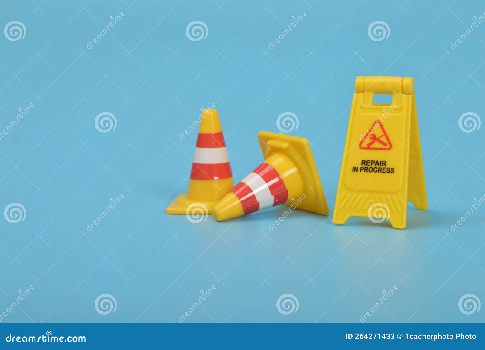 Repair in Progress Sign and Safety Plastic Cones Isolated on a Blue ...