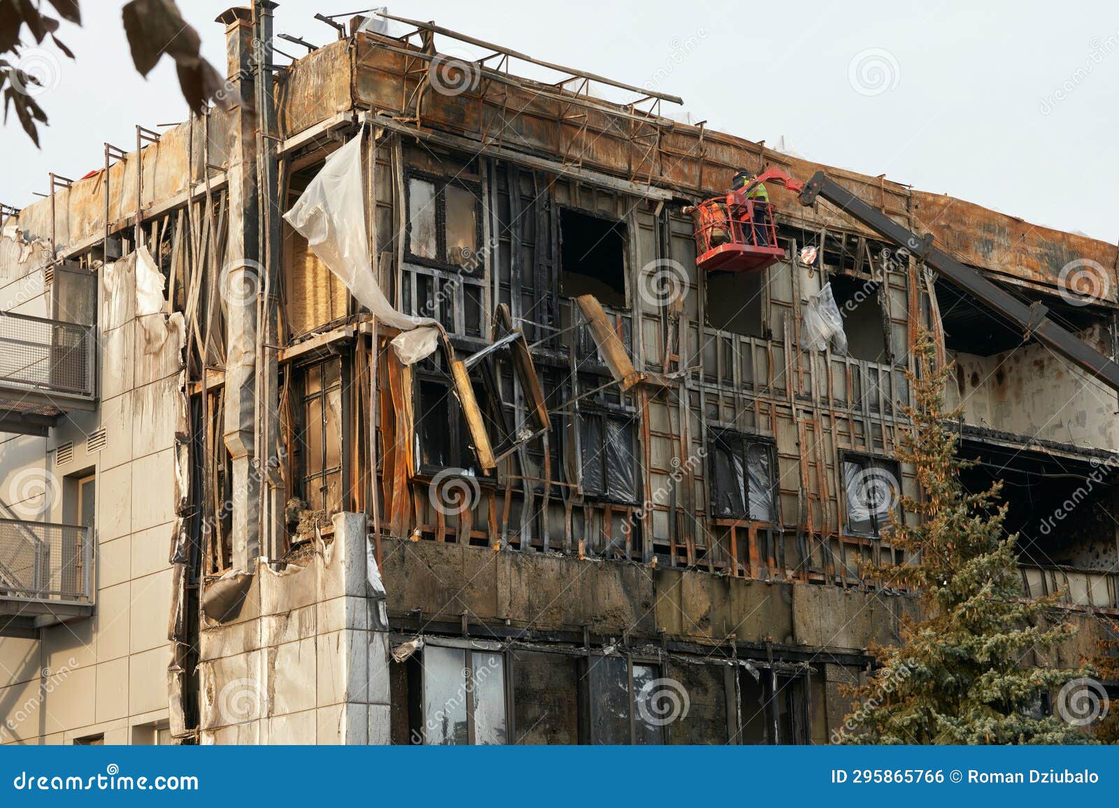 A Repair Team in a Construction Cradle Removes Charred Elements of the ...
