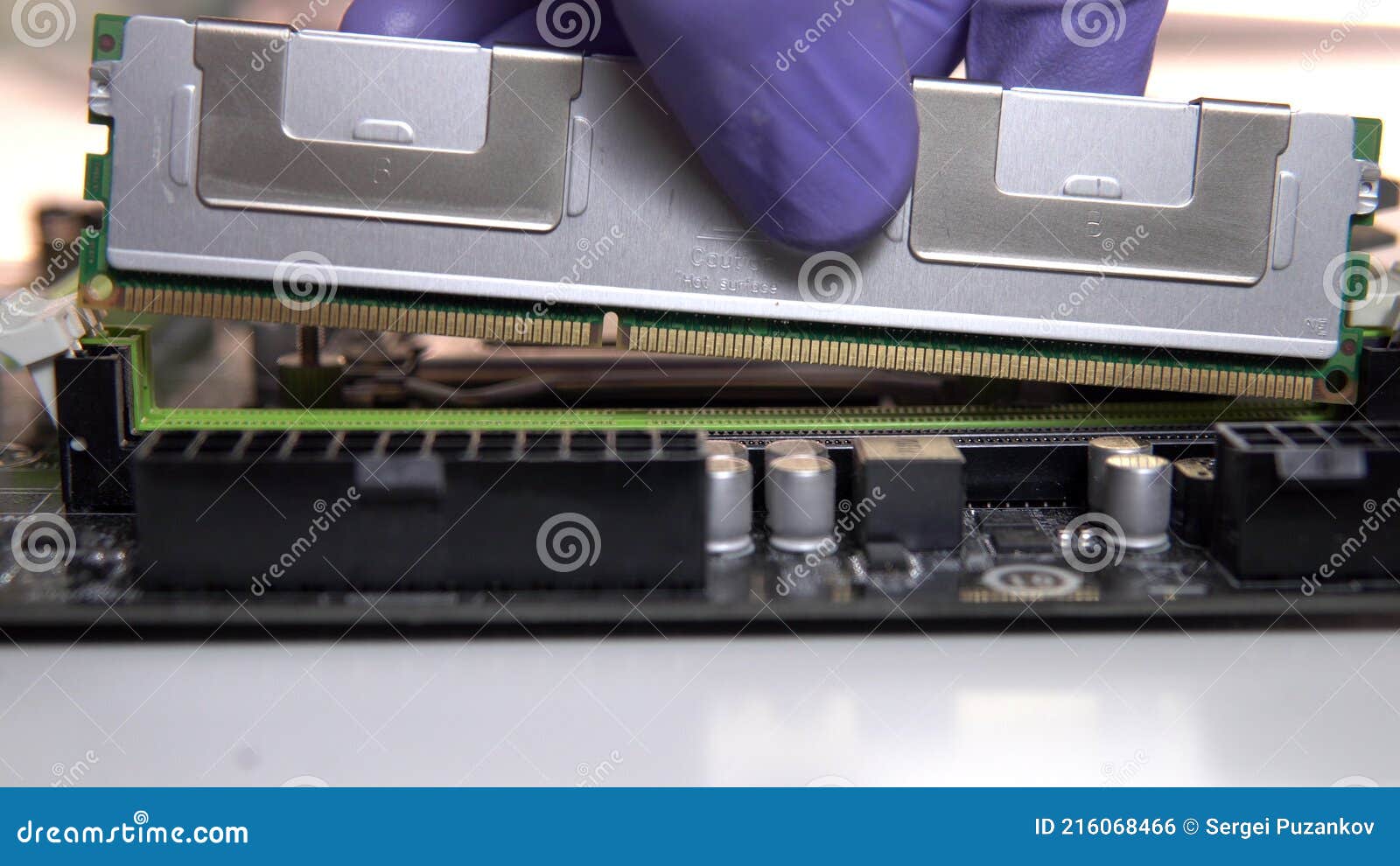 The Repair Technician Inserts a RAM Stick into the Socket on the ...