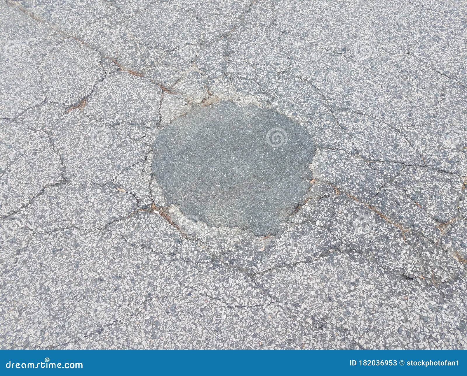 Repaired Hole in Black Asphalt with Cracks Stock Image - Image of ...