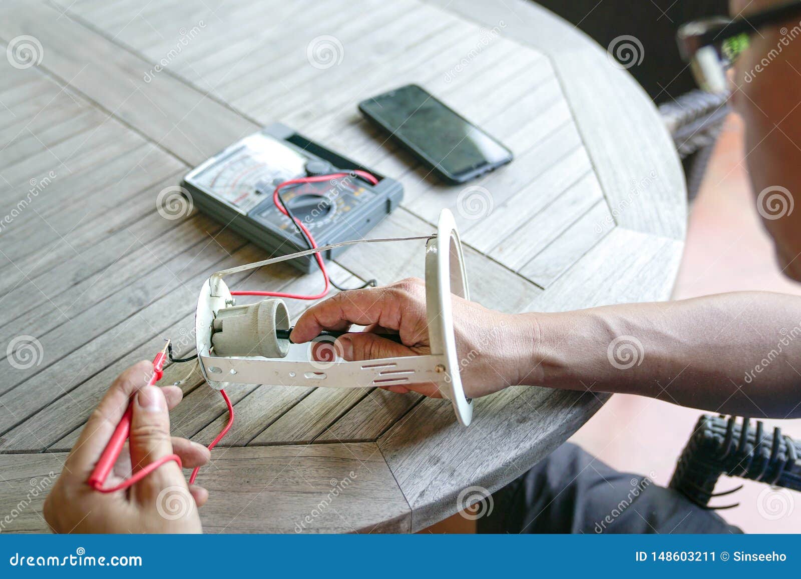 Repairing Light Bulb by Checking Voltage at the Electrical Terminal ...