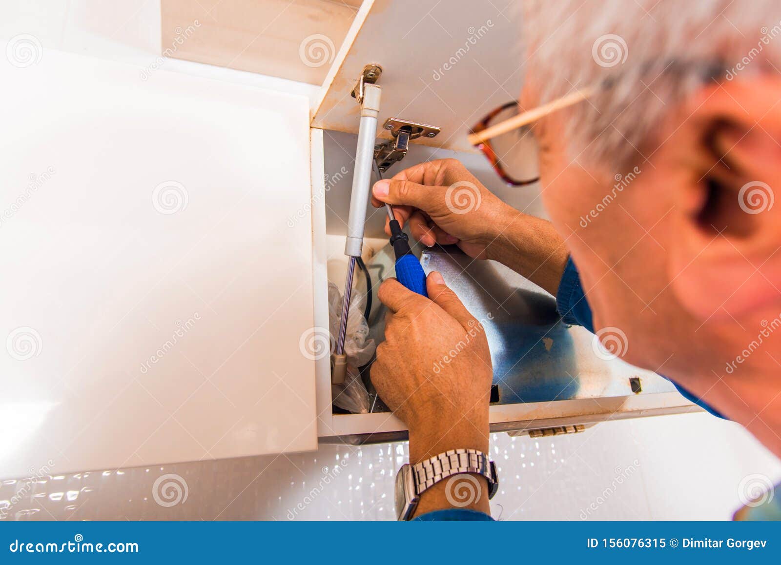 Repairman Fixing the Cupboard Stock Image - Image of installer ...