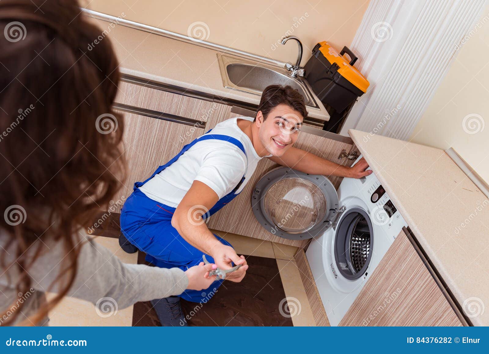 The Repairman Repairing Washing Machine at Kitchen Stock Photo - Image ...