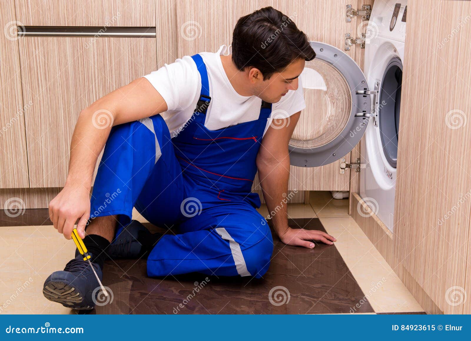 The Repairman Repairing Washing Machine at Kitchen Stock Image - Image ...