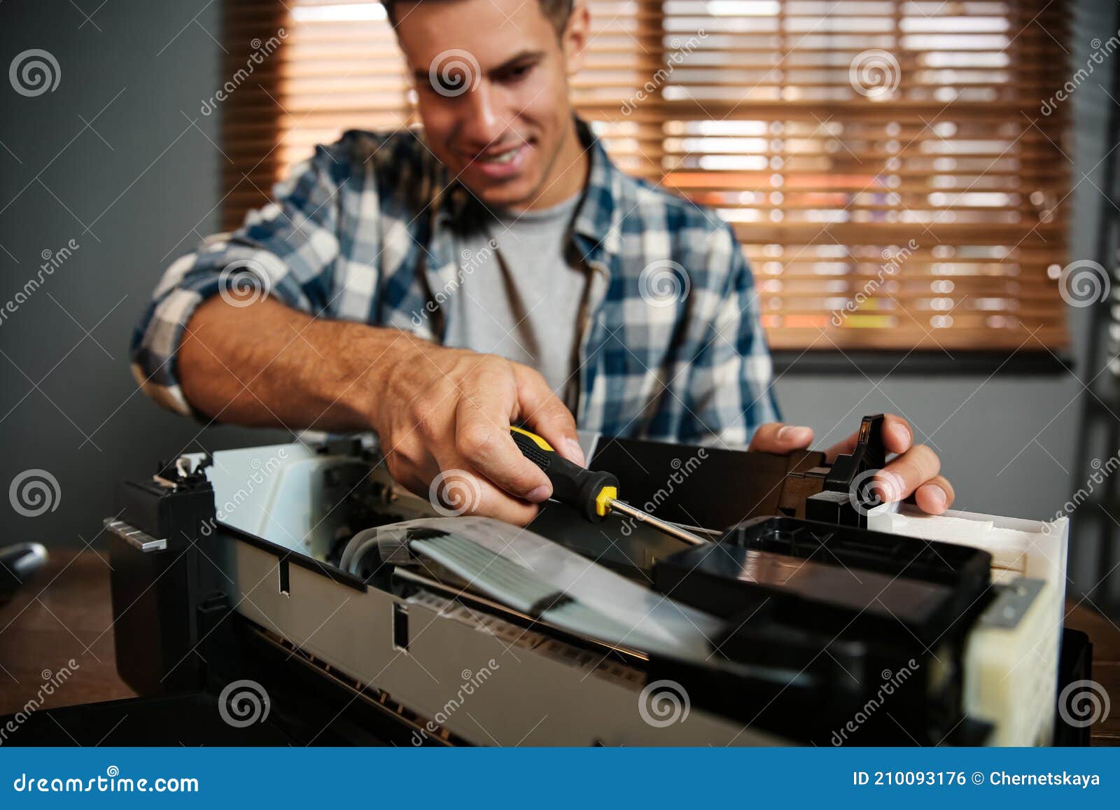 Repairman with Screwdriver Fixing Modern Printer in Office, Focus on ...