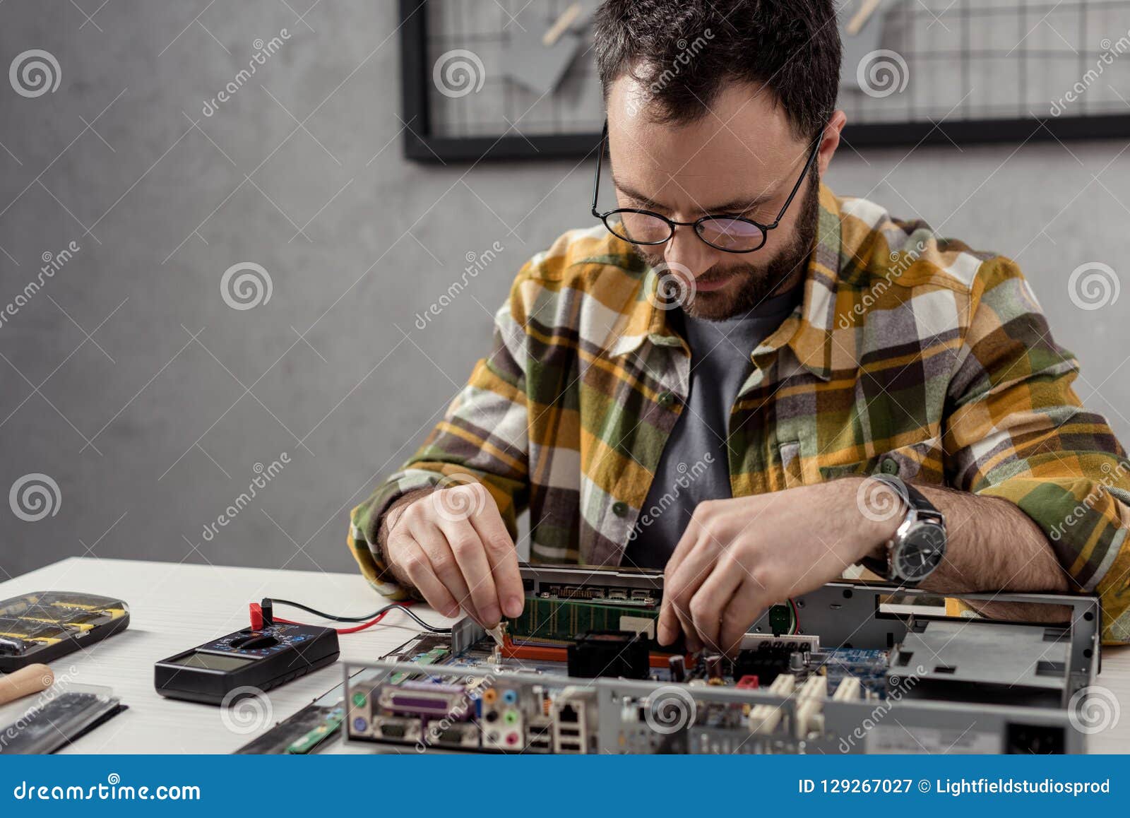 Repairman Using Multimeter while Fixing Broken Computer and Looking ...