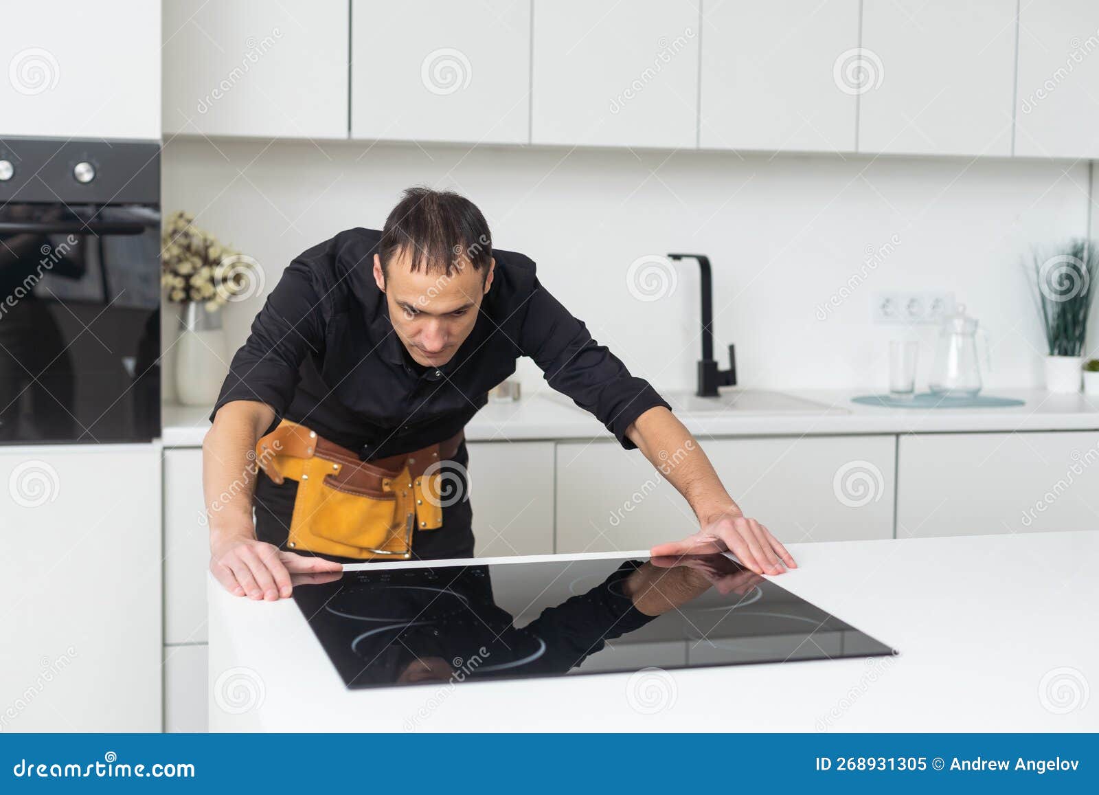 Repairs and Fixing of Control Panel. Man Repairs Hotplate of a Hob ...