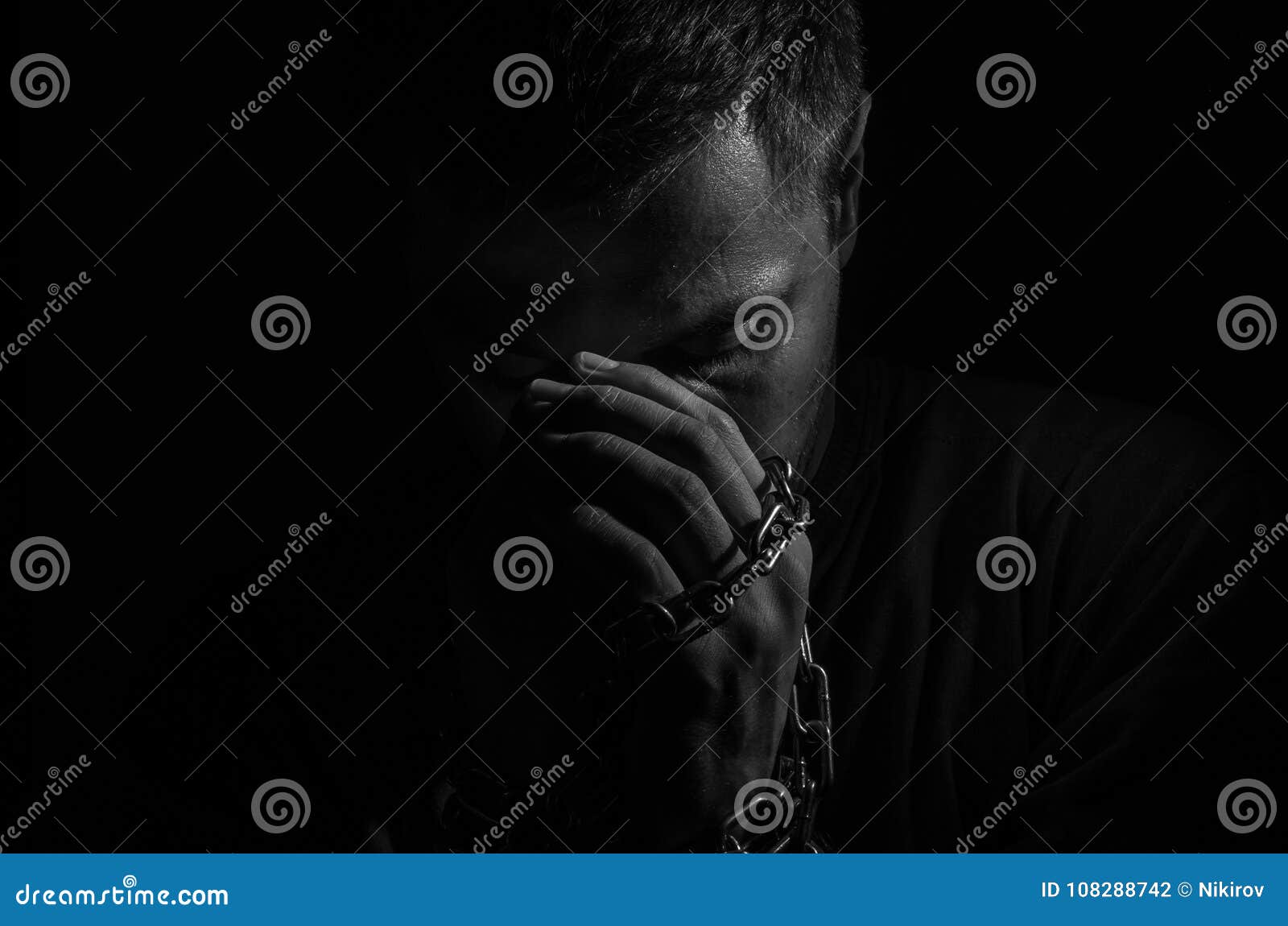 Repented Man Prisoner With His Hands Shackled In Chains On A Dark ...