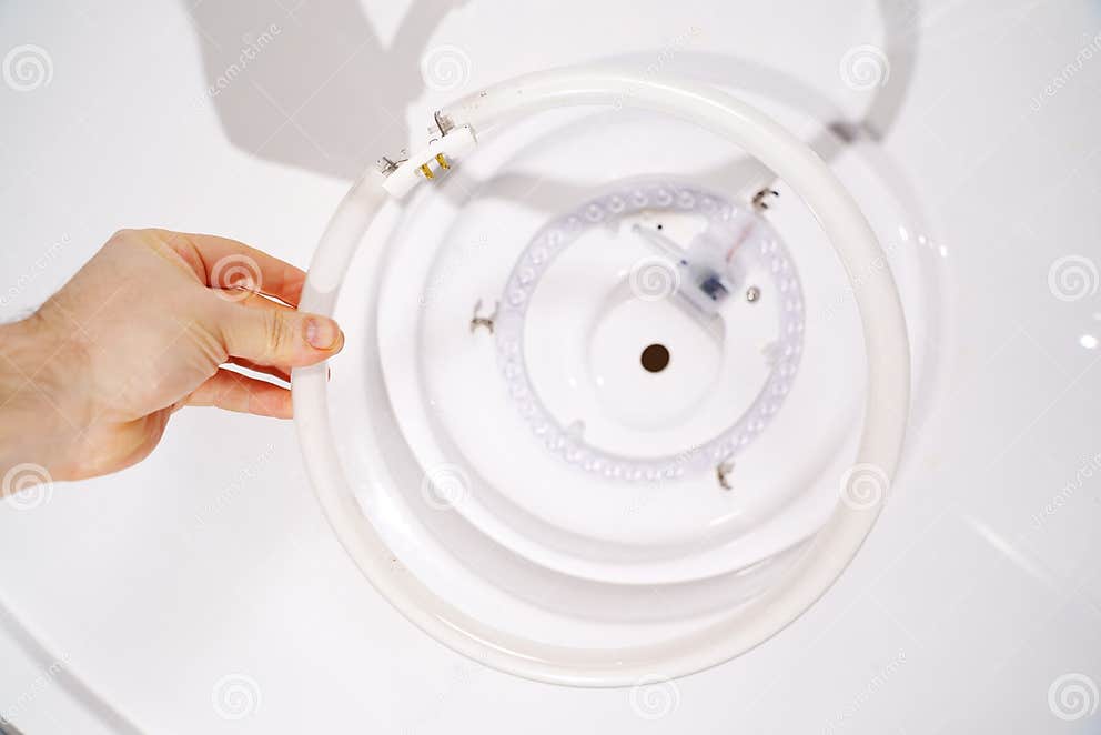 Replacement of an Old Fluorescent Lamp with a Ring LED Module. Stock ...