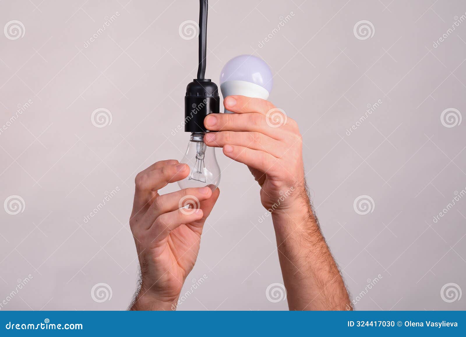 Replacing a Light Bulb with an Energy Efficient One Stock Photo - Image ...