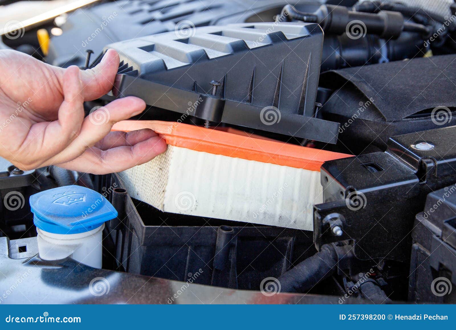 Replacing an Old Dirty Air Filter in the Engine Compartment of a Car ...