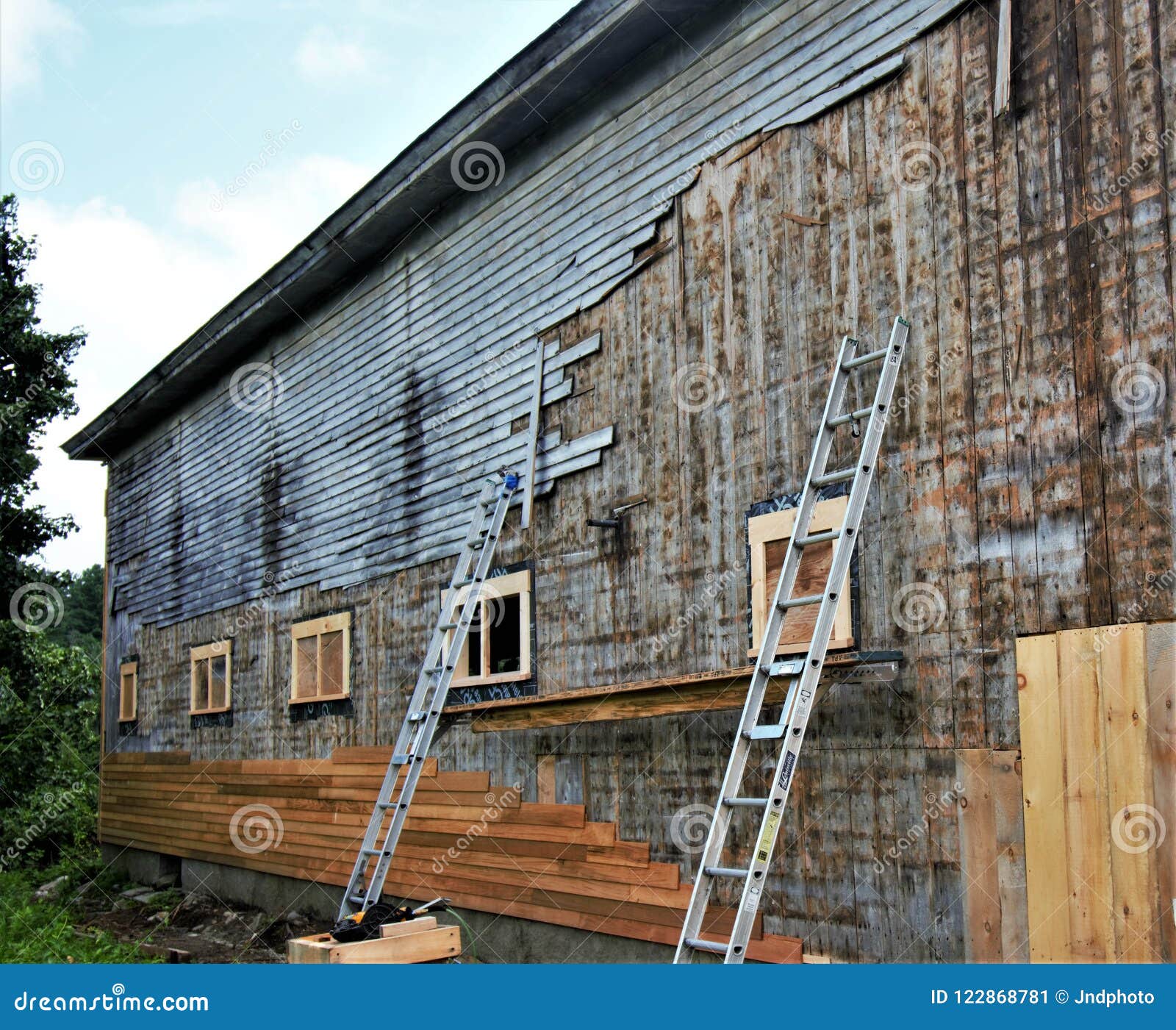 Replacing the Old, Gray Siding of Old Wooden Barn with New Brown Tan ...