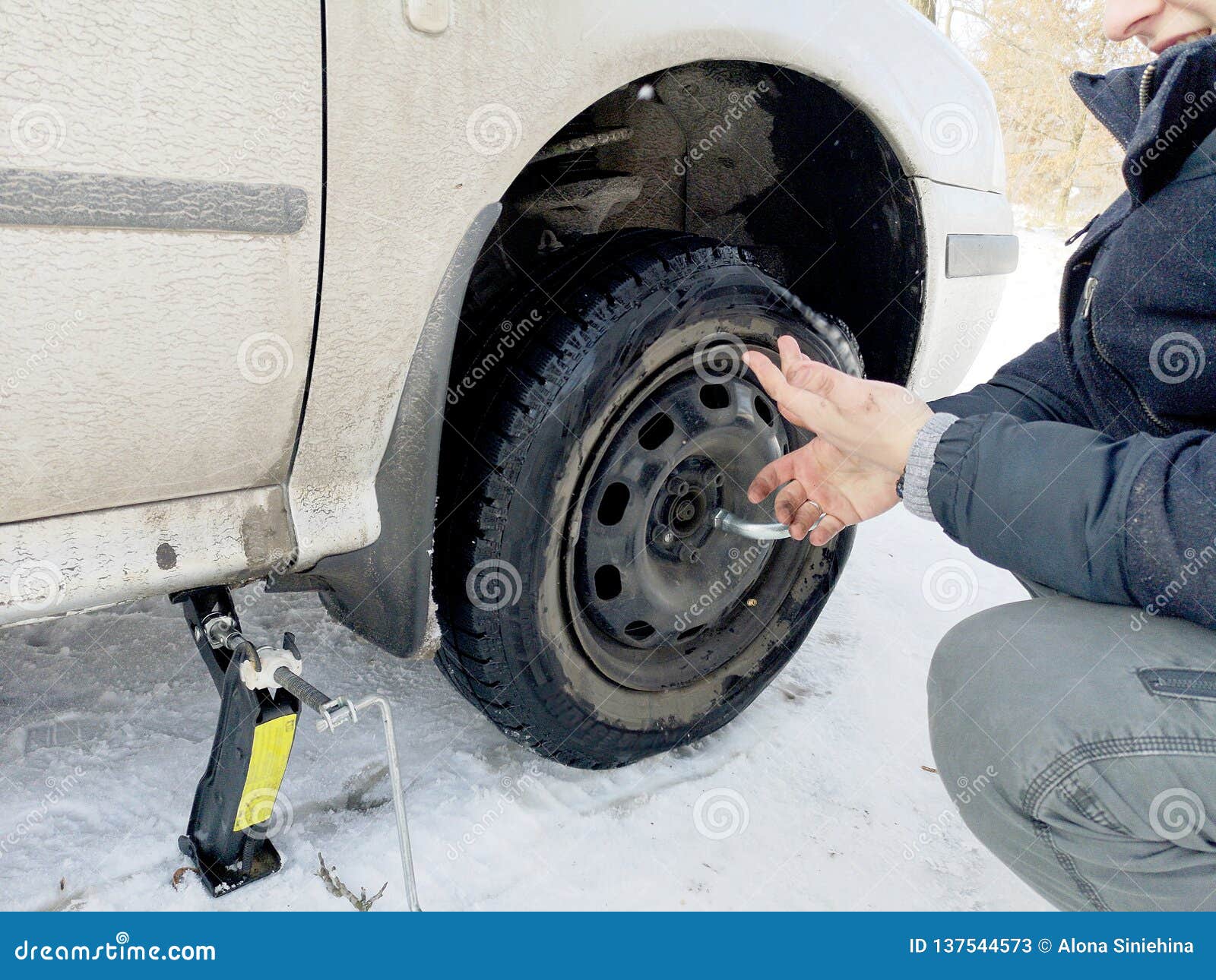 Punched and Flat Tire on the Road. Replacing the Wheel with a Jack by ...