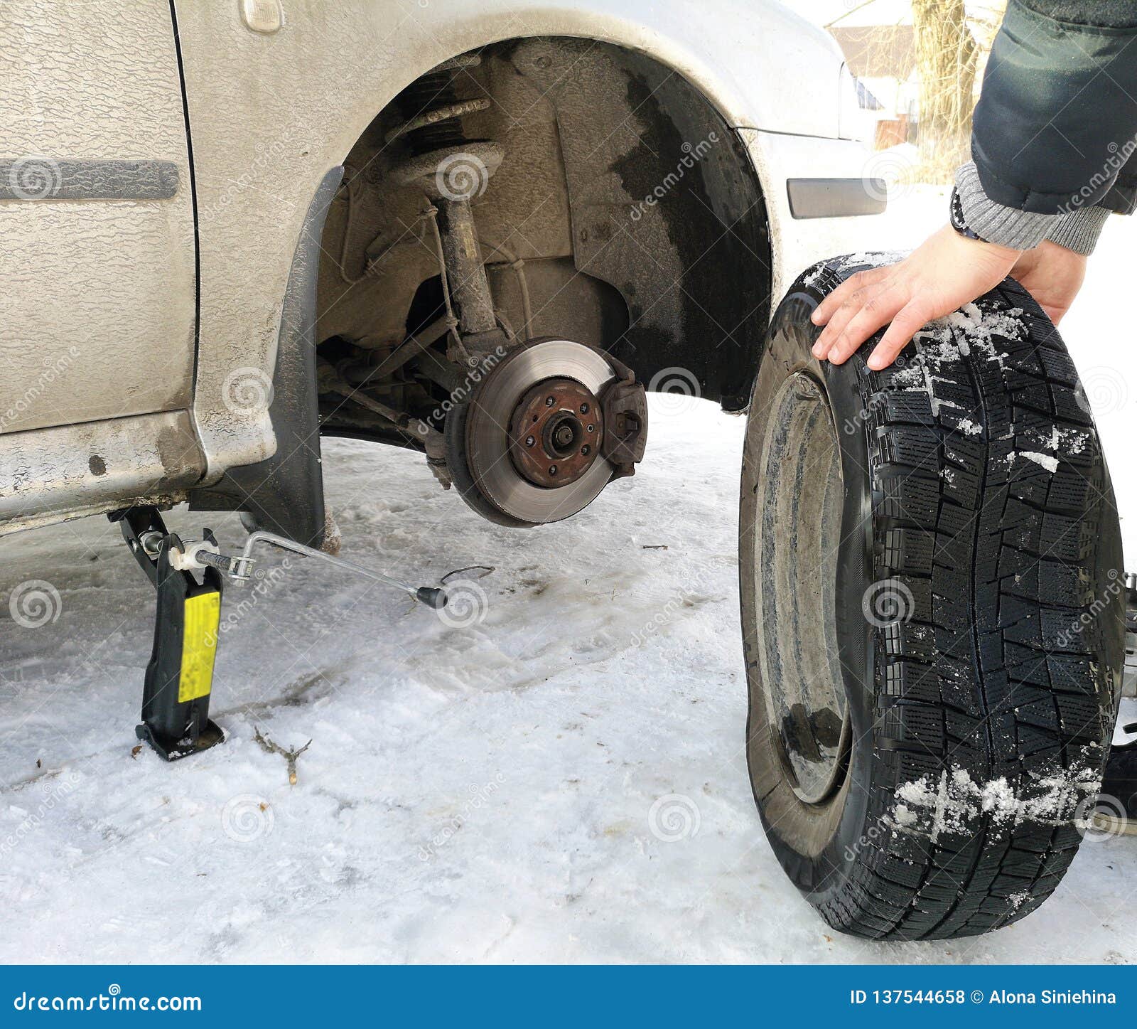 Punched and Flat Tire on the Road. Replacing the Wheel with a Jack by ...