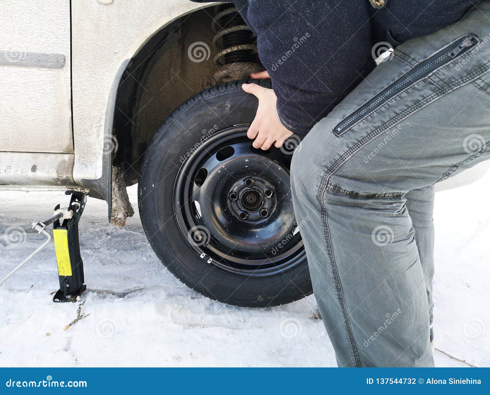 Punched and Flat Tire on the Road. Replacing the Wheel with a Jack by ...