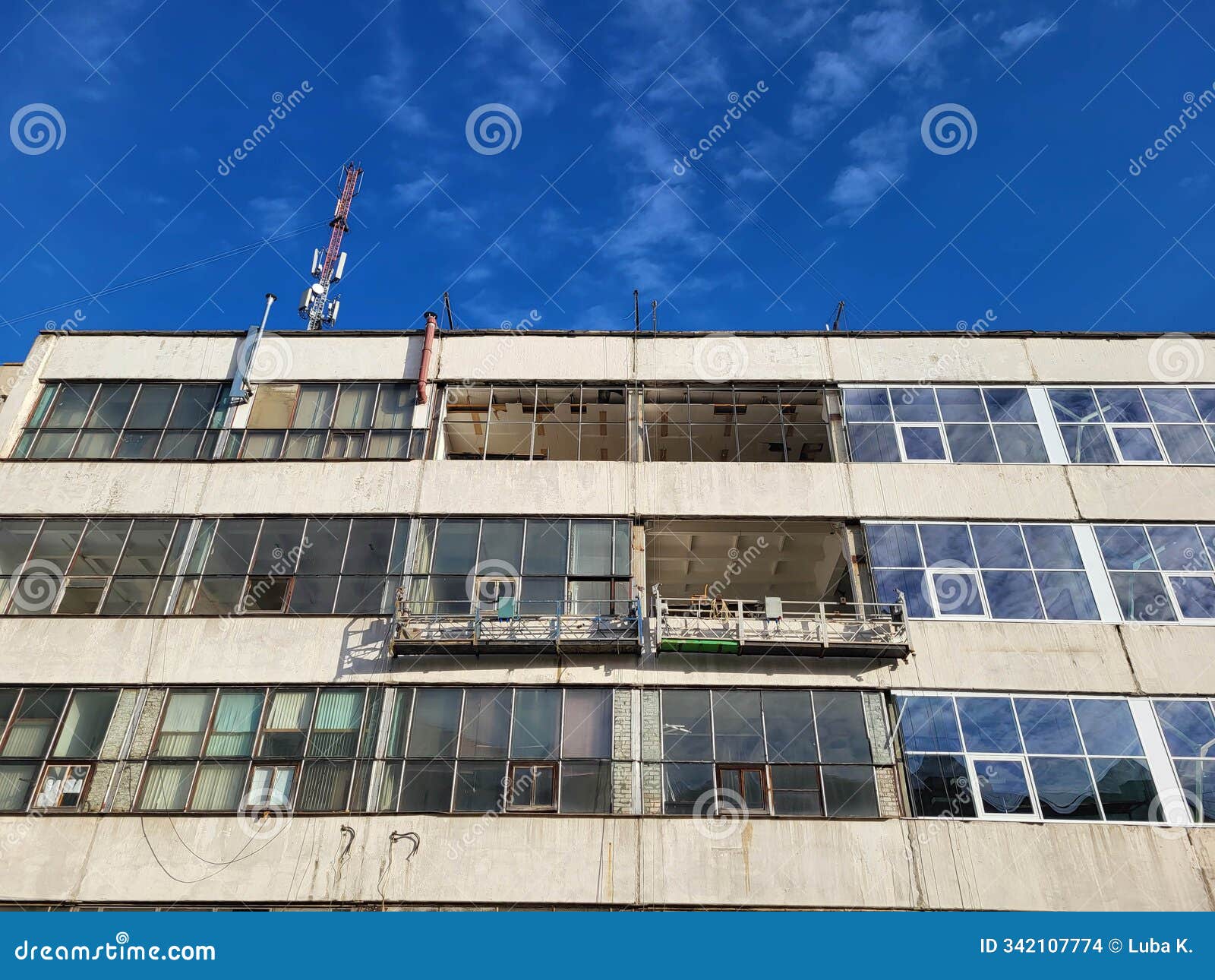 Replacing Windows in a High-rise Building Against a Blue Sky Background ...