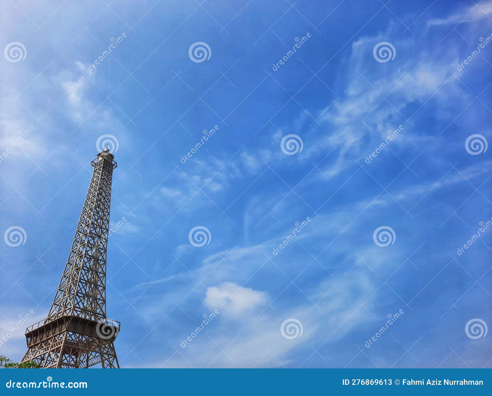 Replica Eiffel Tower with Blue Sky and Wispy Clouds Stock Image - Image ...